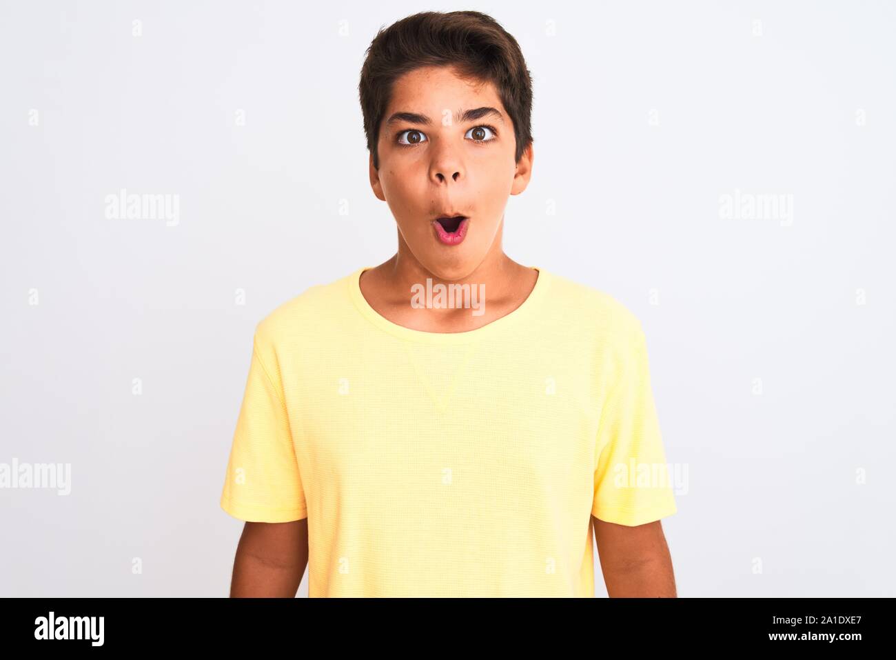 Handsome teenager boy standing over white isolated background afraid ...