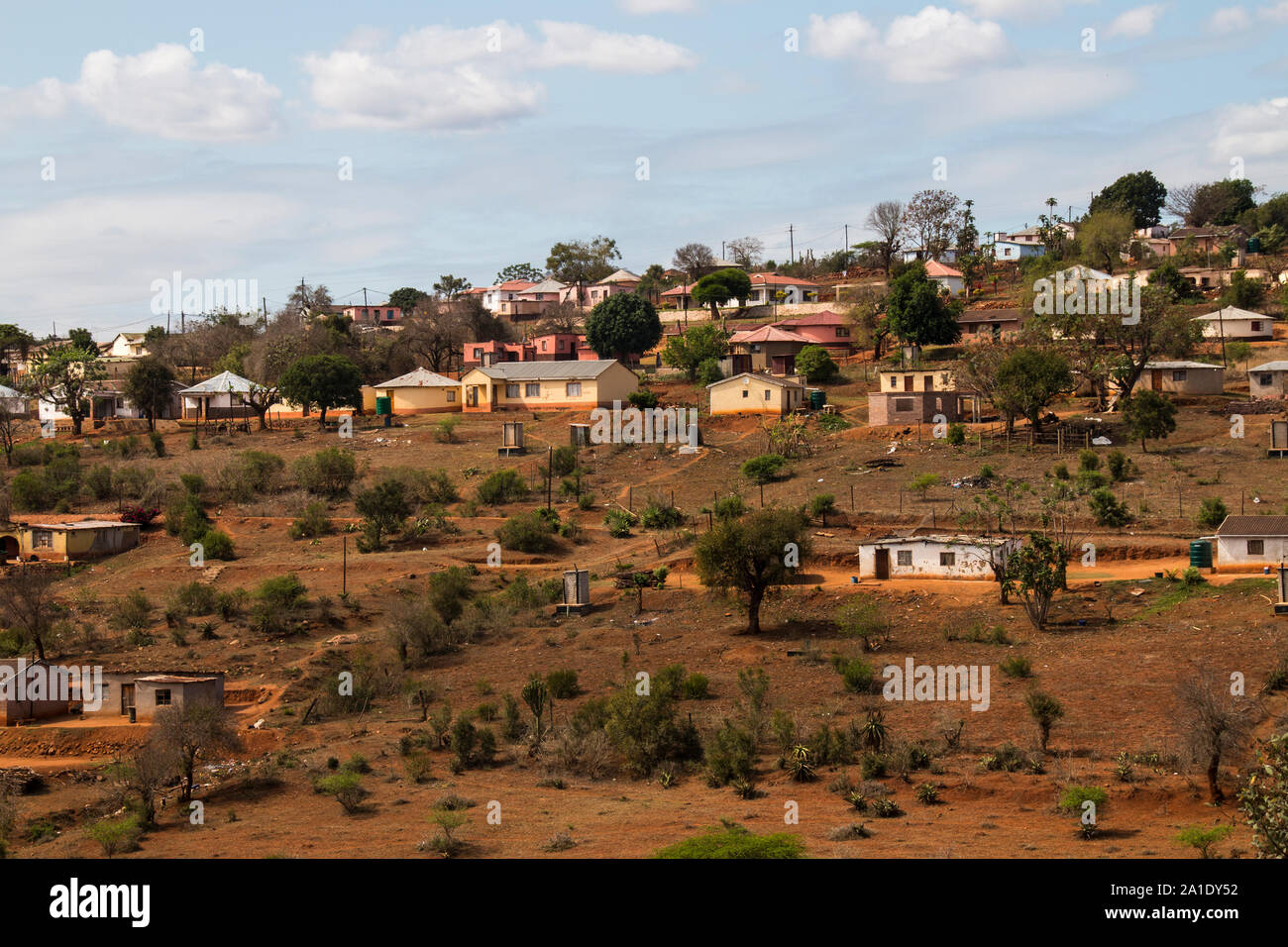 Housing and huts scattered informally on hill in rural south africa ...