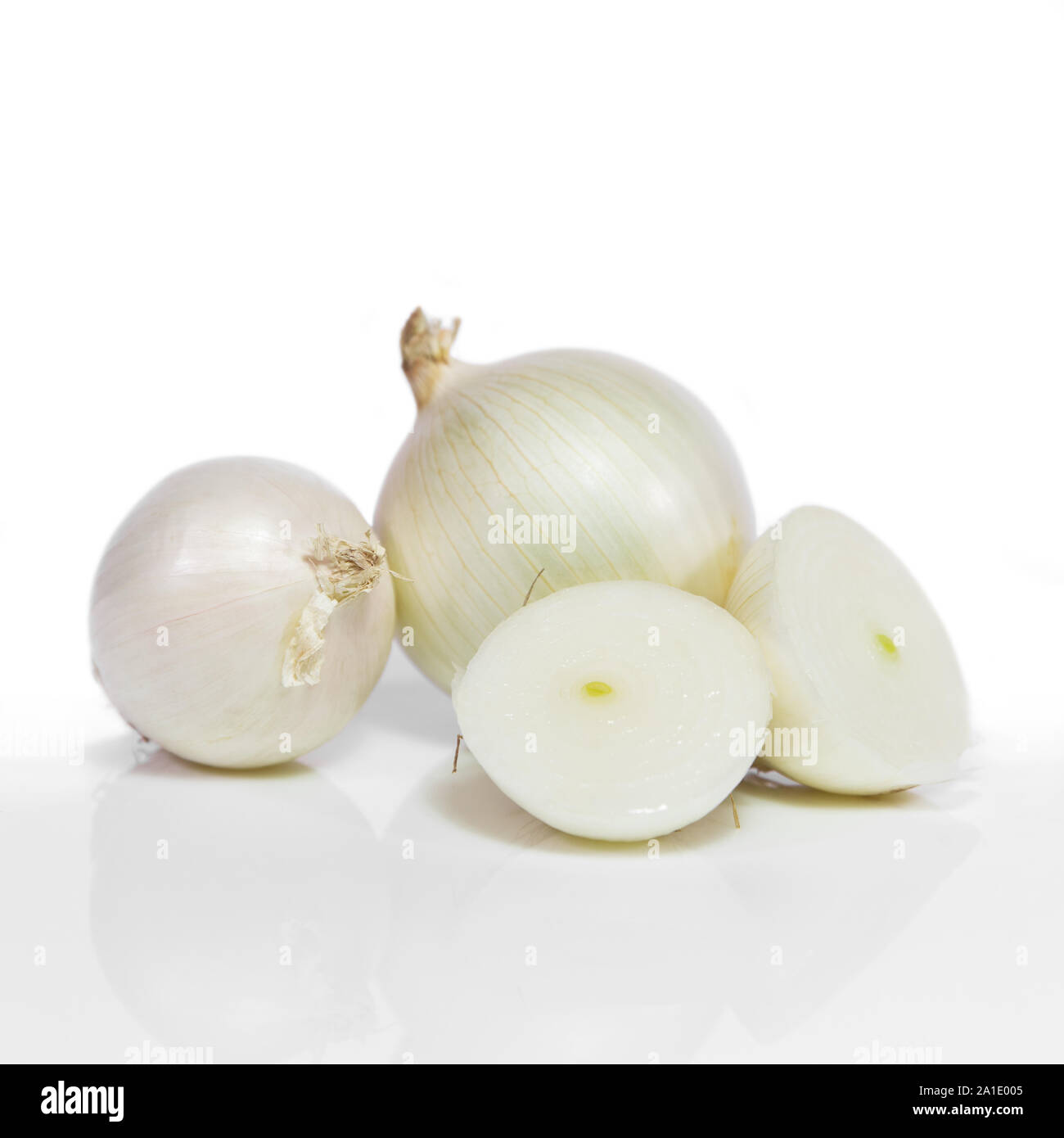 white onions, unpeeled and sliced in front of white Stock Photo - Alamy