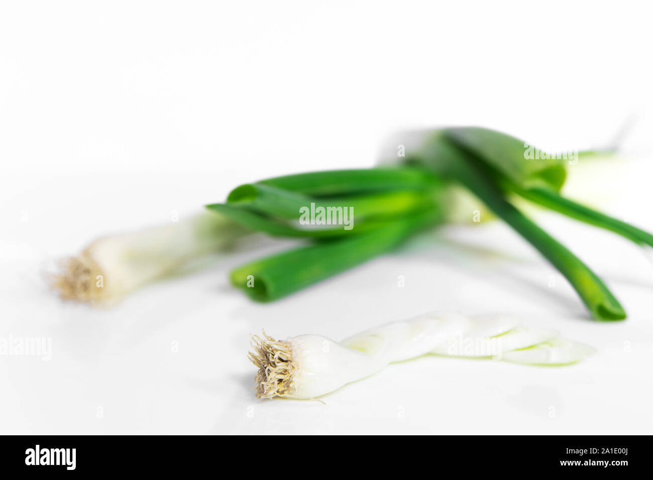 some scallions in front of white background Stock Photo - Alamy