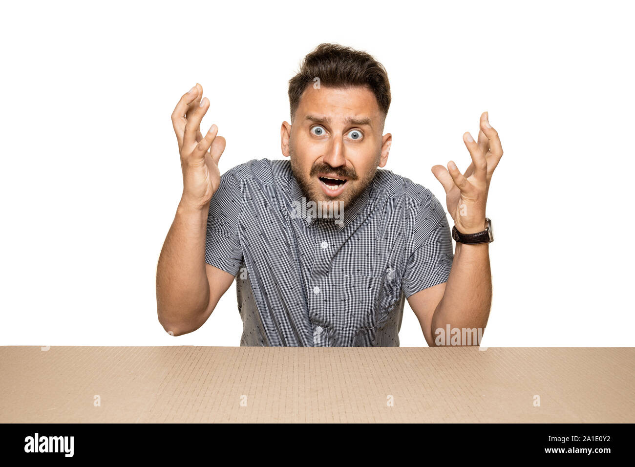 Shocked and astonished man opening the biggest postal package. Excited ...