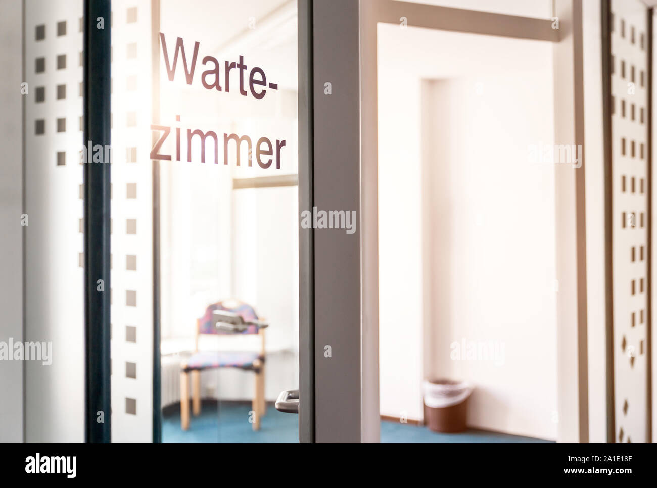 empty room with glass door and german word wartezimmer which means ...
