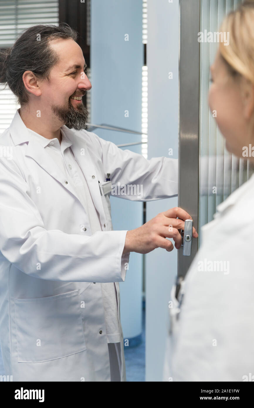 two medicine workers having a conversation in front of a medicine ...