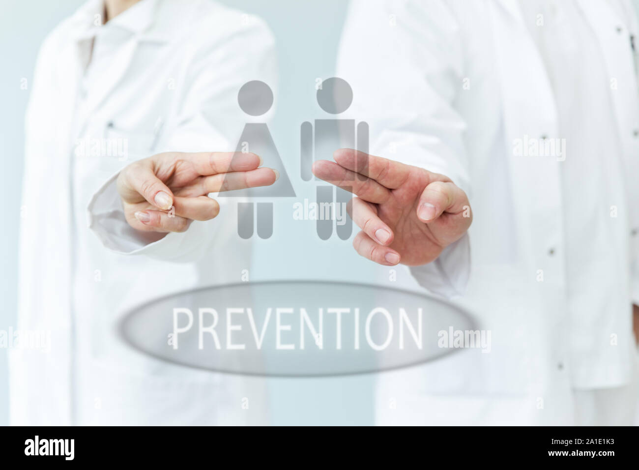 two doctors supporting prevention by pushing a touchscreen icon with ...
