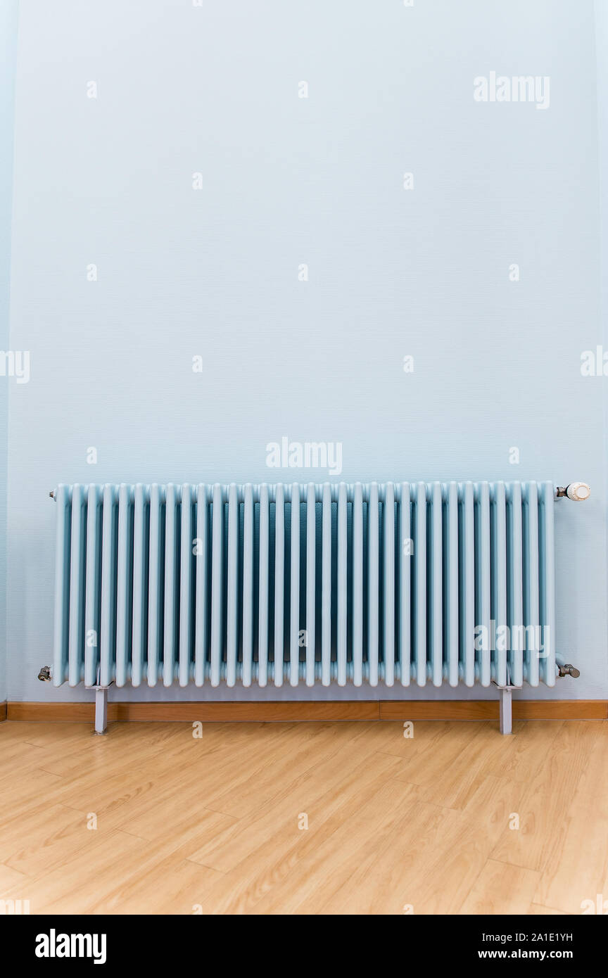 blue radiator in an empty room, blue wall in the background Stock Photo ...