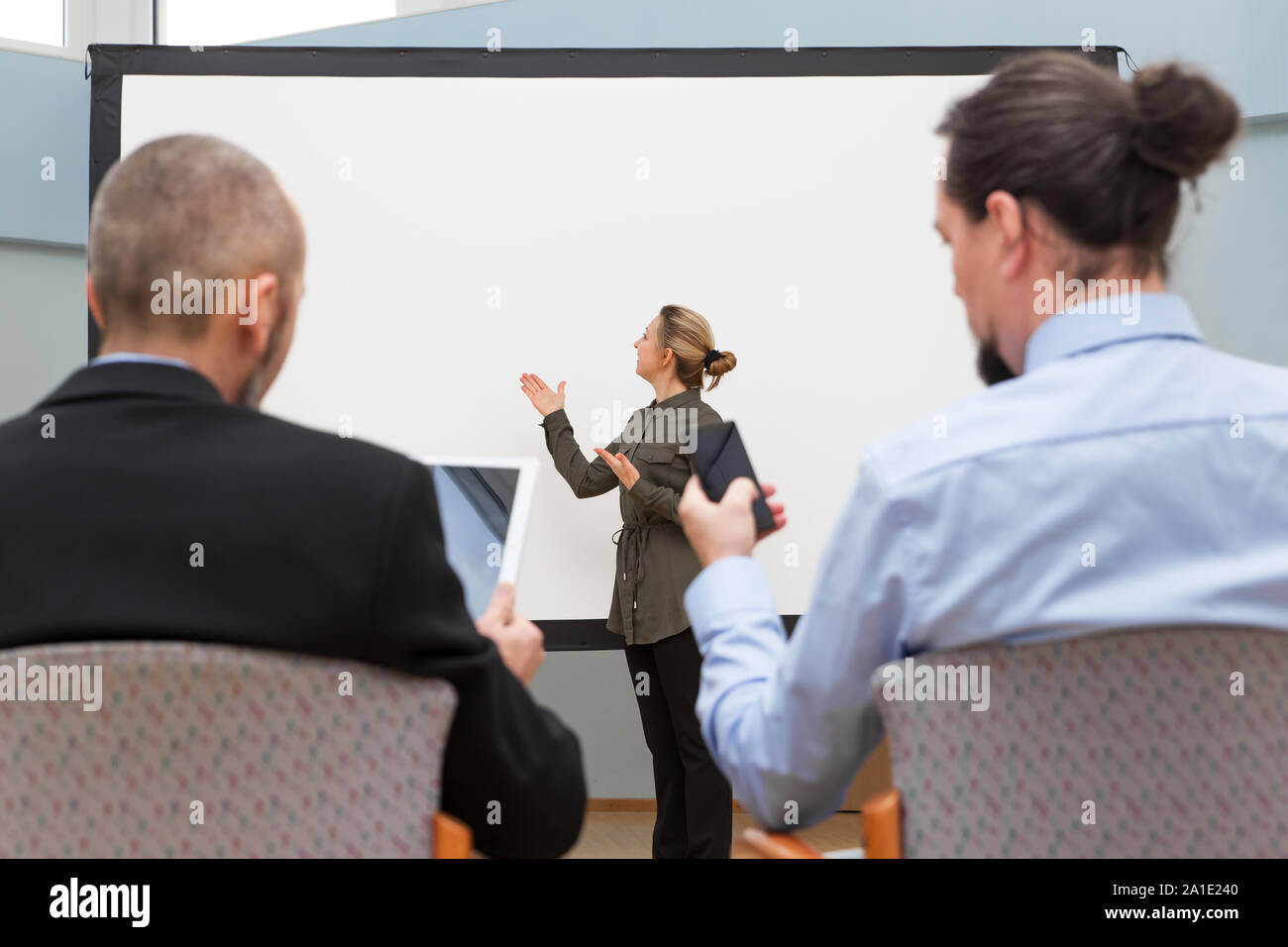 businesswoman is doing a presentation in front of staff Stock Photo - Alamy