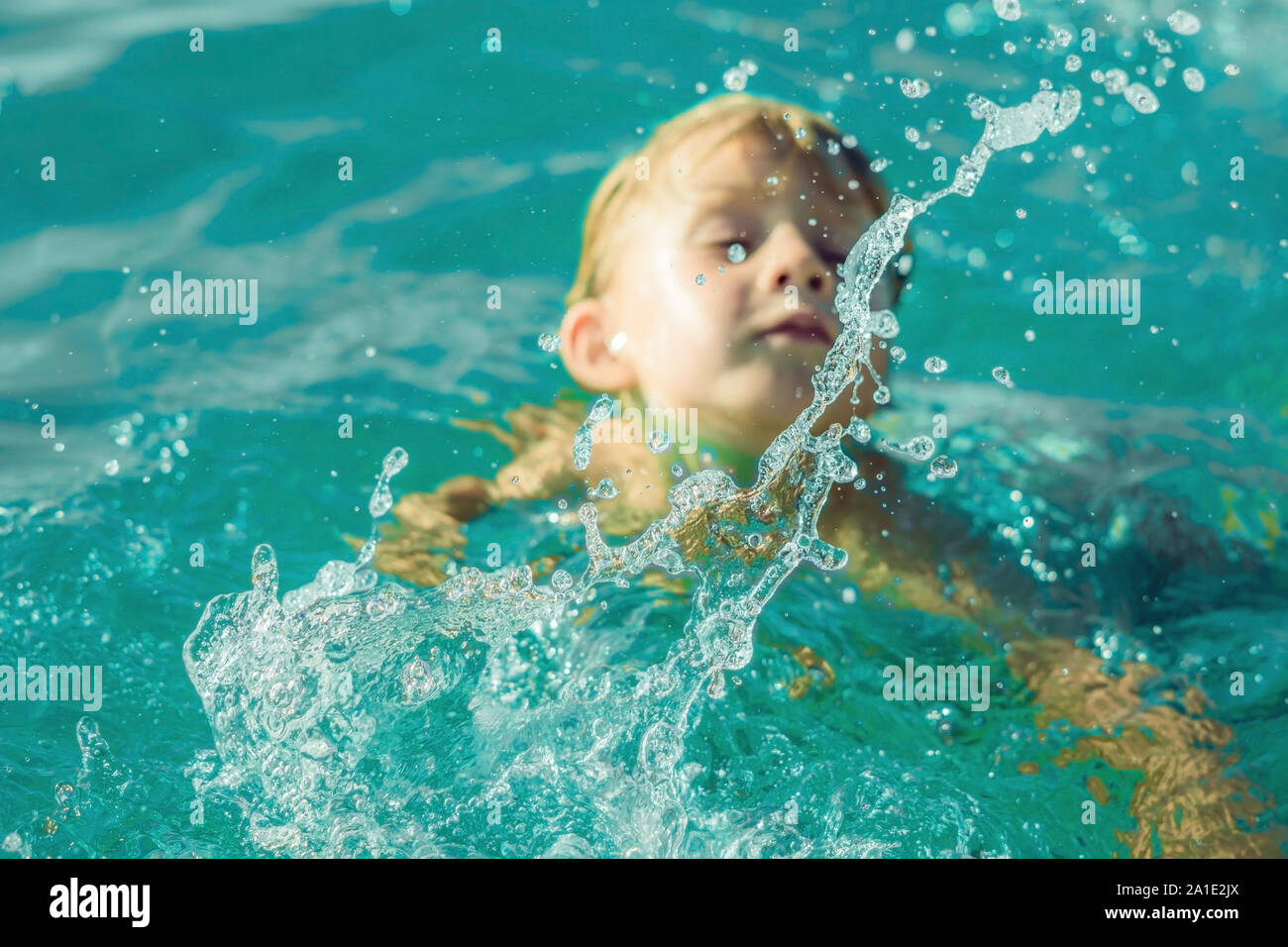 boy swims in the blue tropical sea. hot summer Stock Photo - Alamy