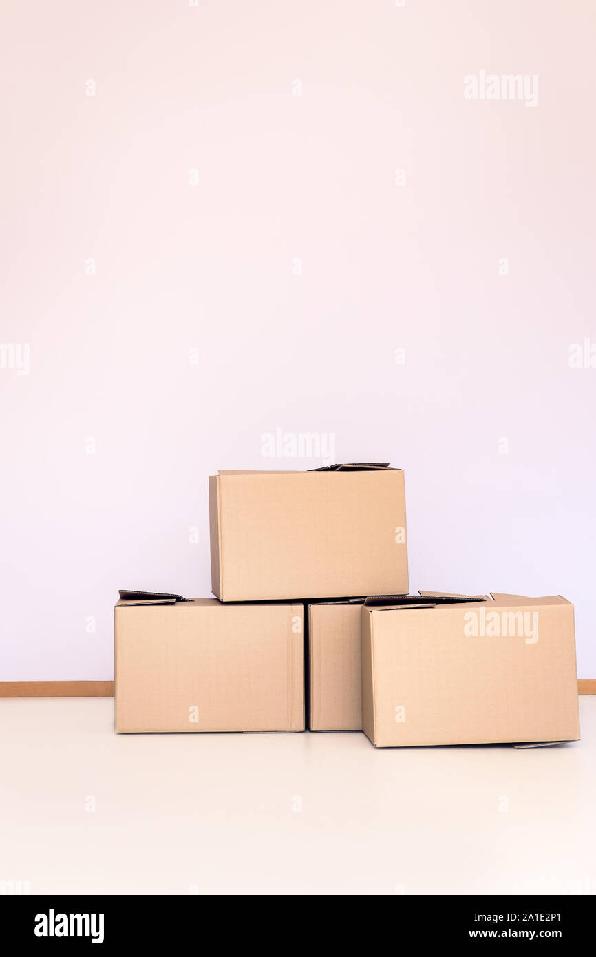 lot of brown moving boxes in an empty, pink room Stock Photo - Alamy
