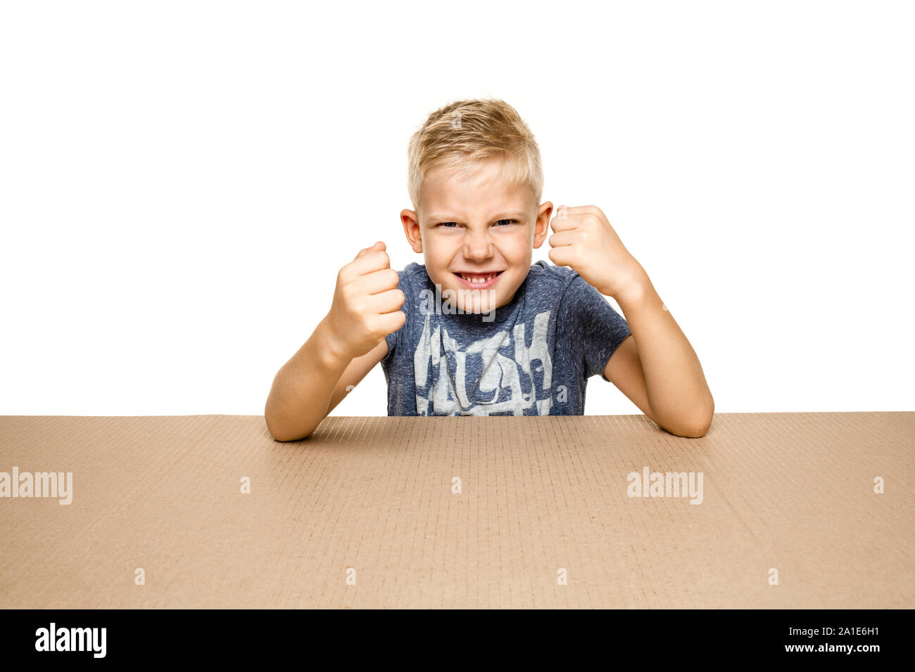 Cute and upset little boy opening the biggest postal package ...