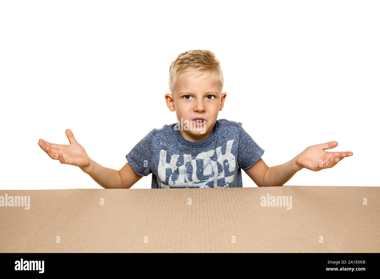 Cute and upset little boy opening the biggest postal package ...