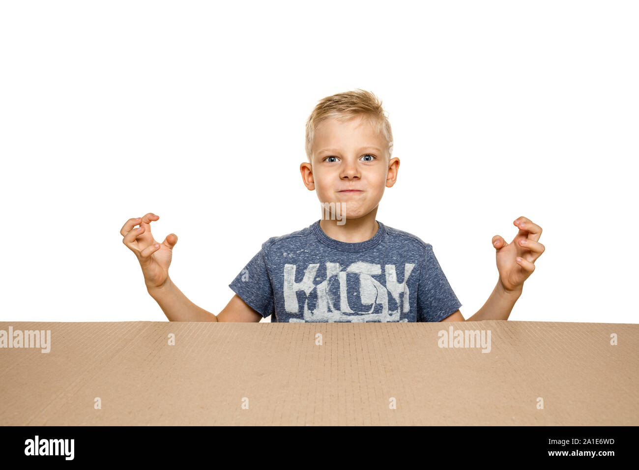 Cute and upset little boy opening the biggest postal package ...