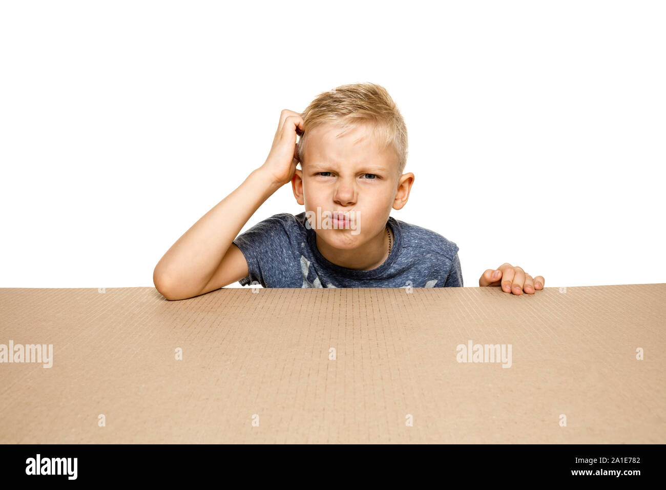 Cute and upset little boy opening the biggest postal package ...