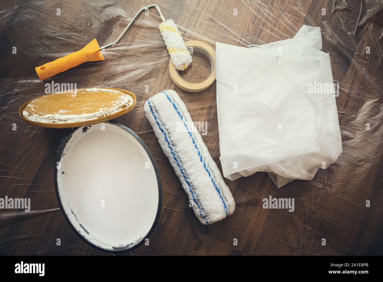 Flat lay, wall paint, roller and protective gown for Painting and ...