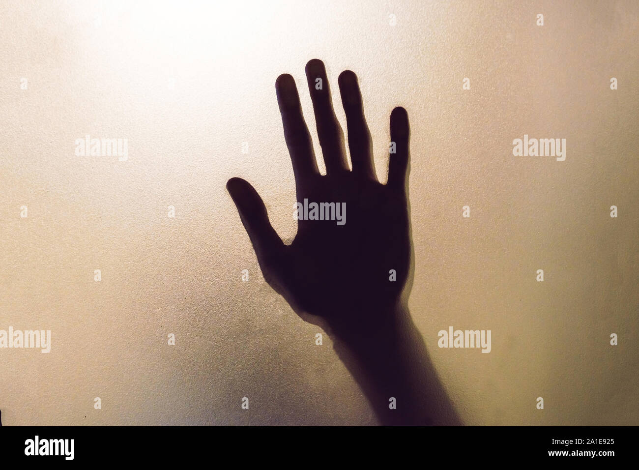 Silhouette hand against frosted glass hi-res stock photography and ...