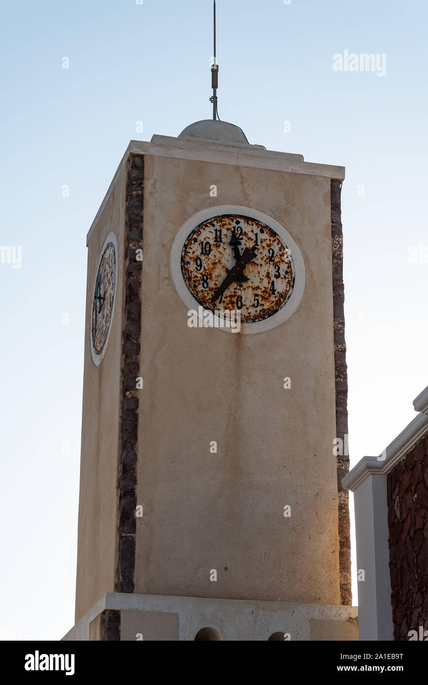 The rusted clock face on the clock tower of Oia in Santorini Stock ...