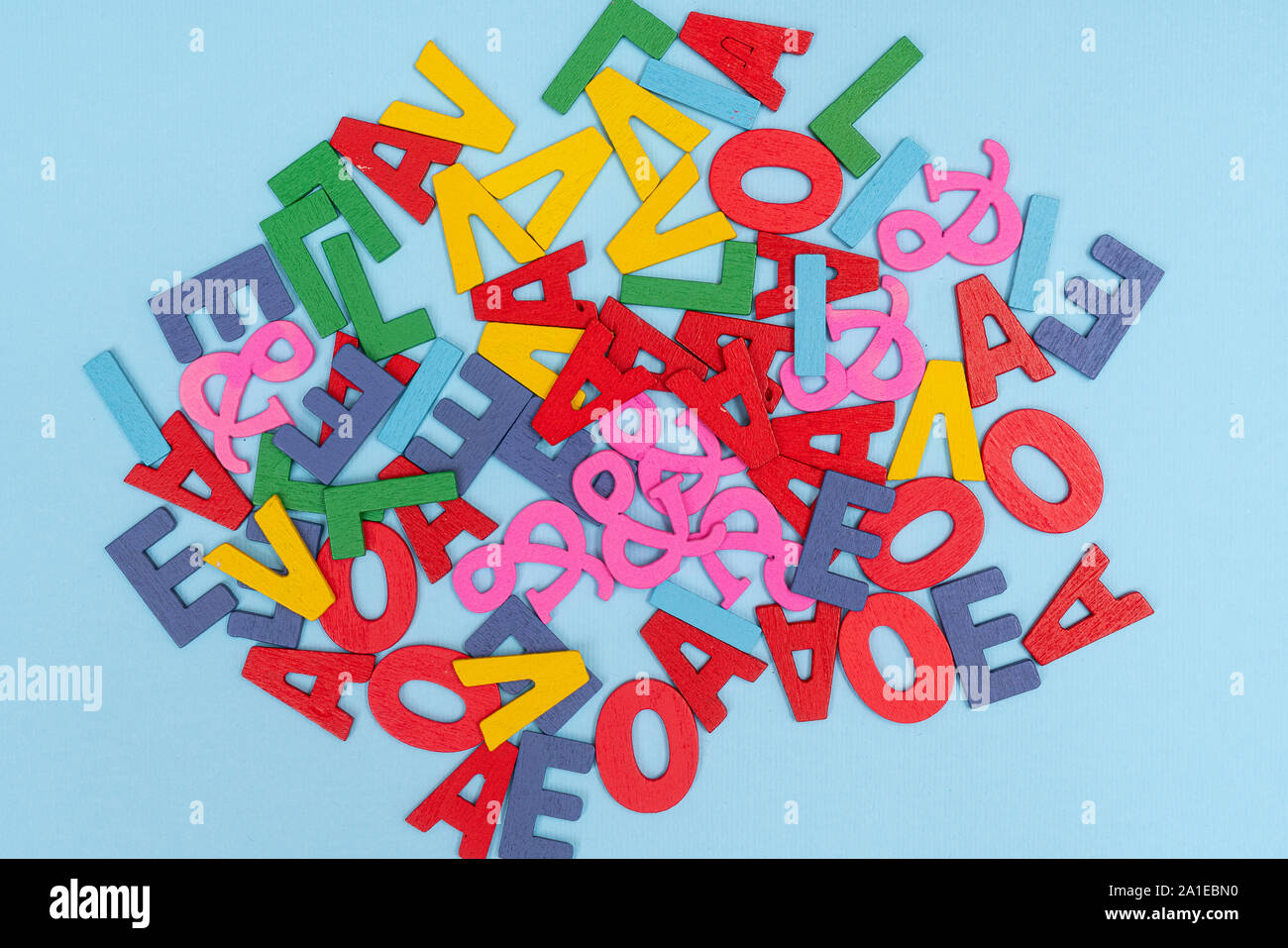 some letters of the colorful alphabet in scattered order on a colored ...