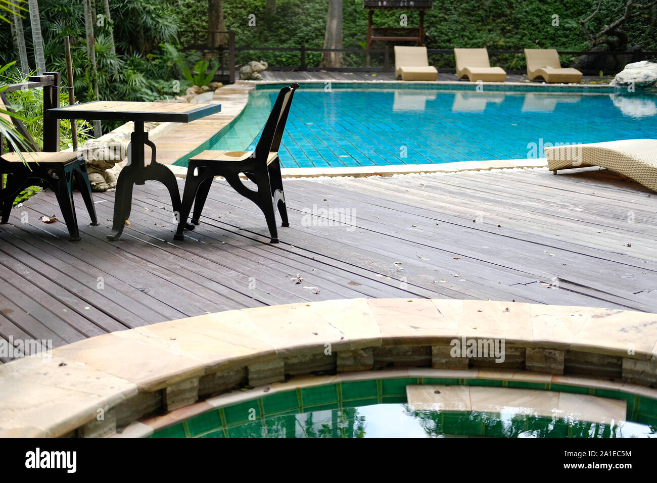 chair desk table on poolside of swimming pool in hotel resort Stock ...