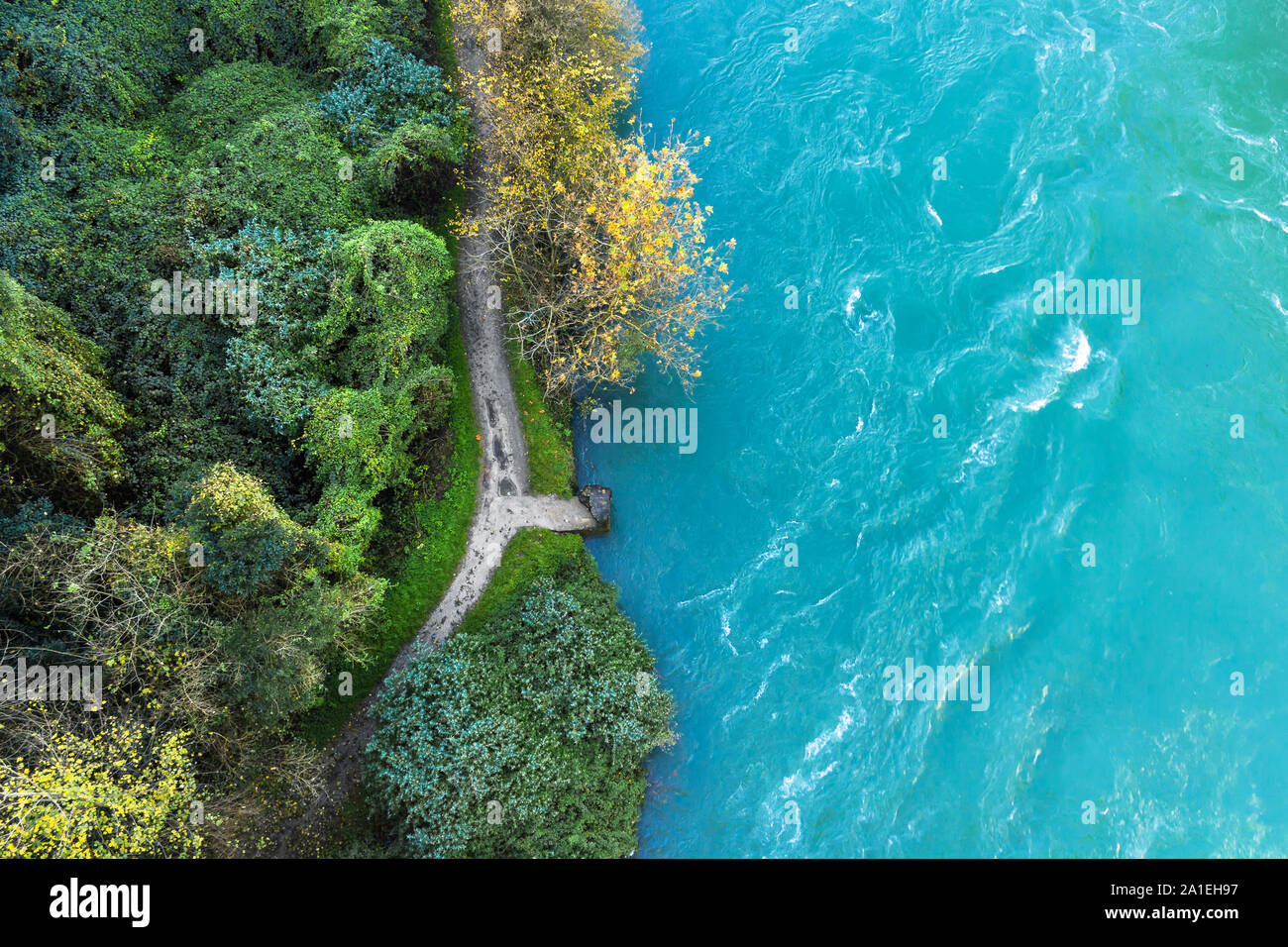 Top-down drone view of rapids of mountain river with small stone pier ...