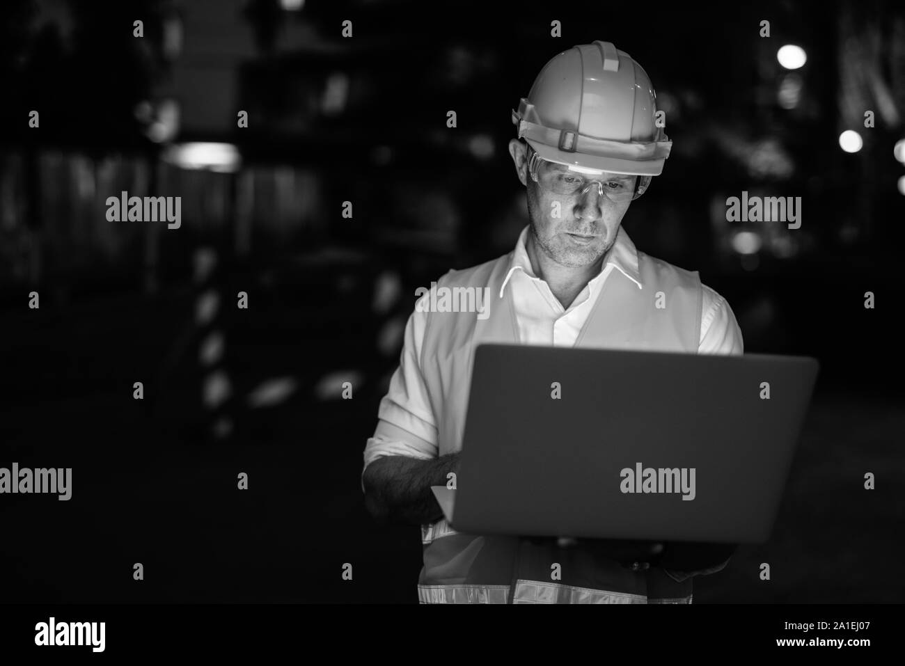 Construction worker at the construction site using laptop computer ...