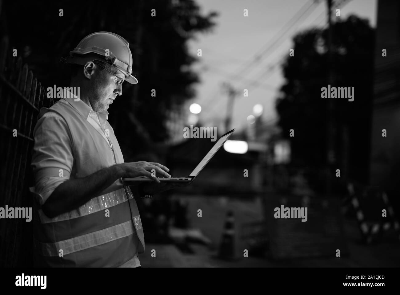 Construction worker at the construction site using laptop computer ...