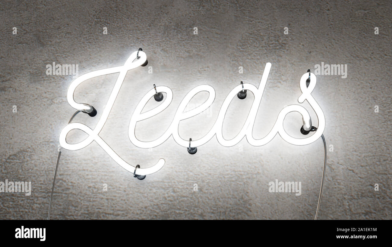 Bright White Neon sign that says the word Leeds on a concrete wall ...