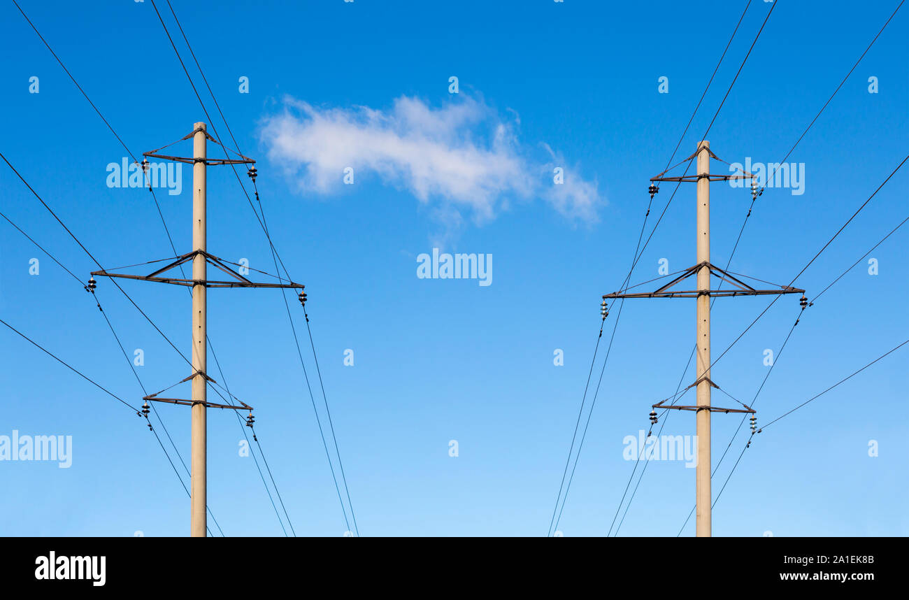 Two symmetrically located concrete power line poles with metal ...