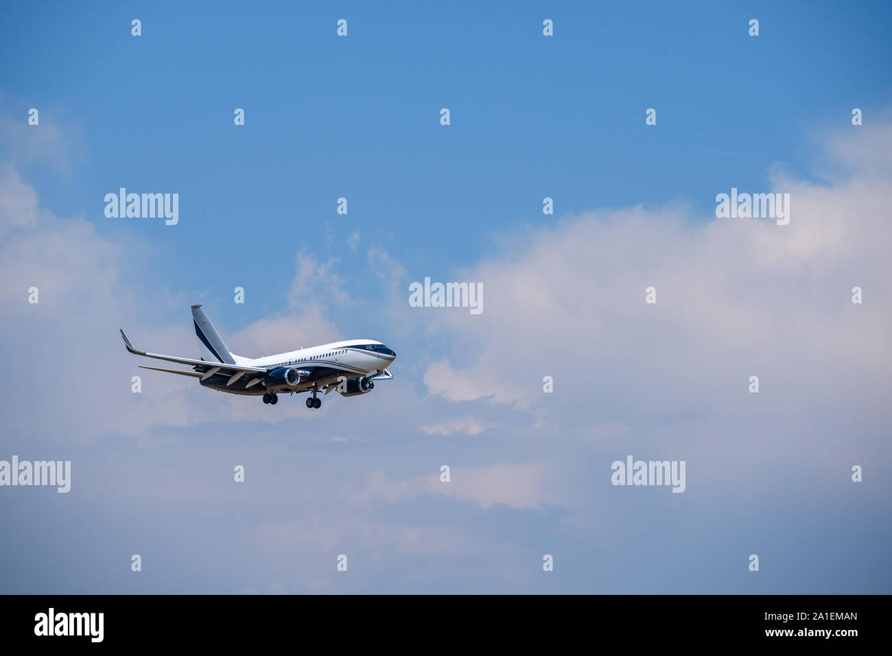 Passenger airplane flying in blue sky, side view Stock Photo - Alamy