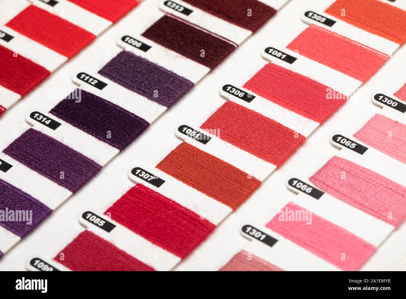 Red violet and pink color hue yarn thread sample swatches close-up ...