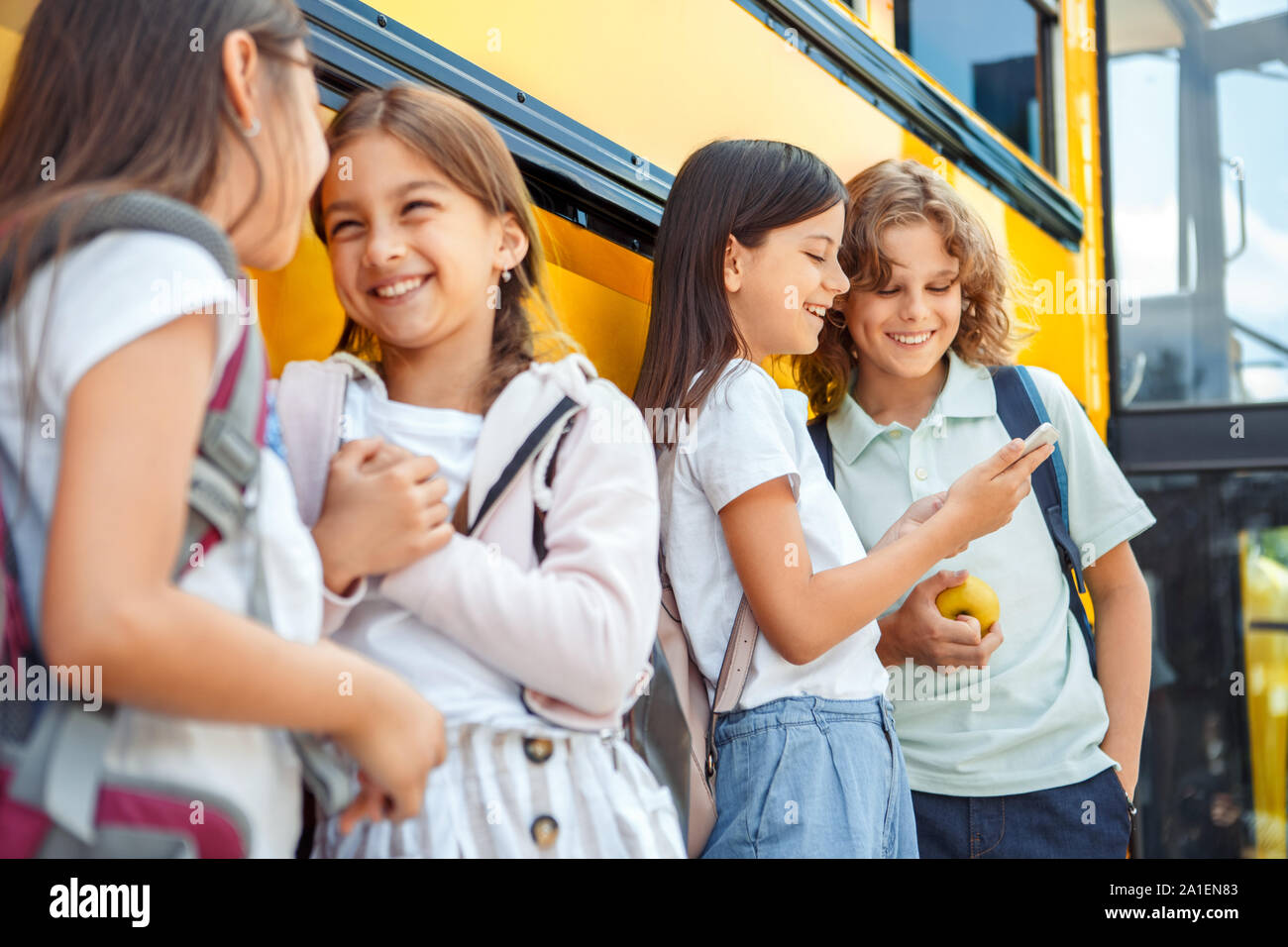 Children talking school bus hi-res stock photography and images - Alamy