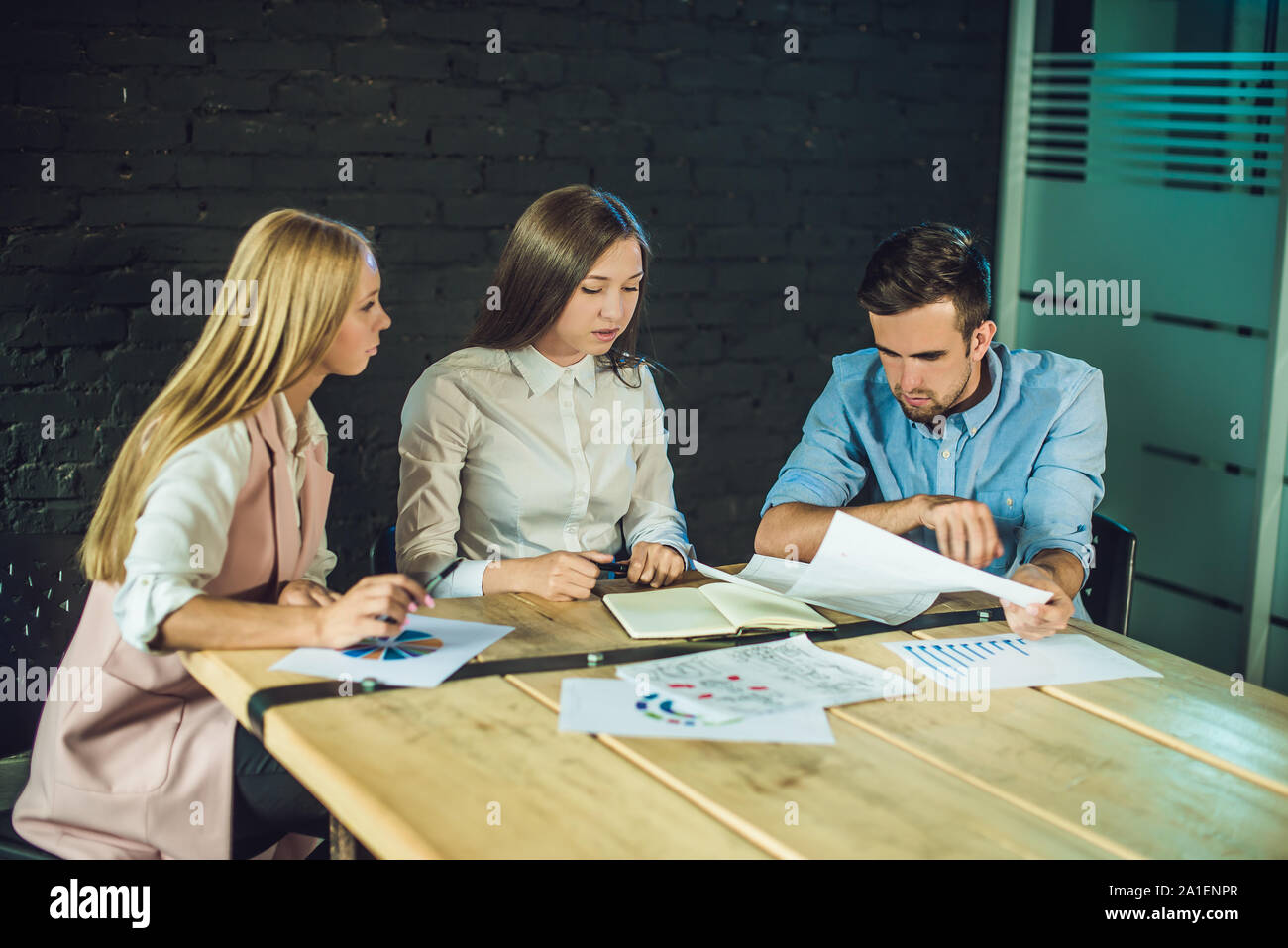 Young team of coworkers watching storyboard for shooting video in ...
