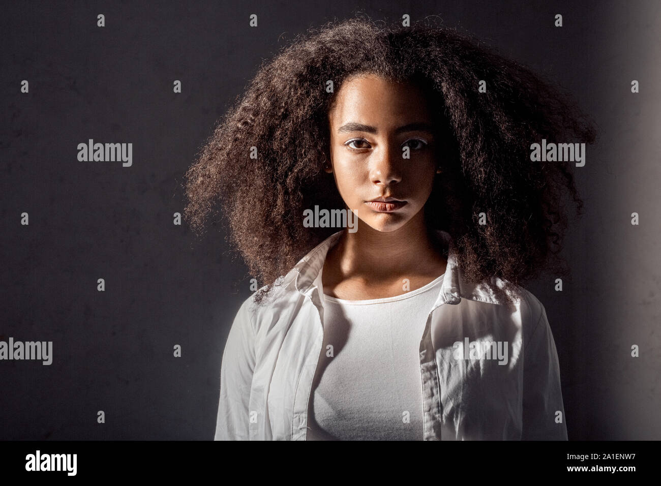African descent girl wearing white outfit standing isolated on gray ...