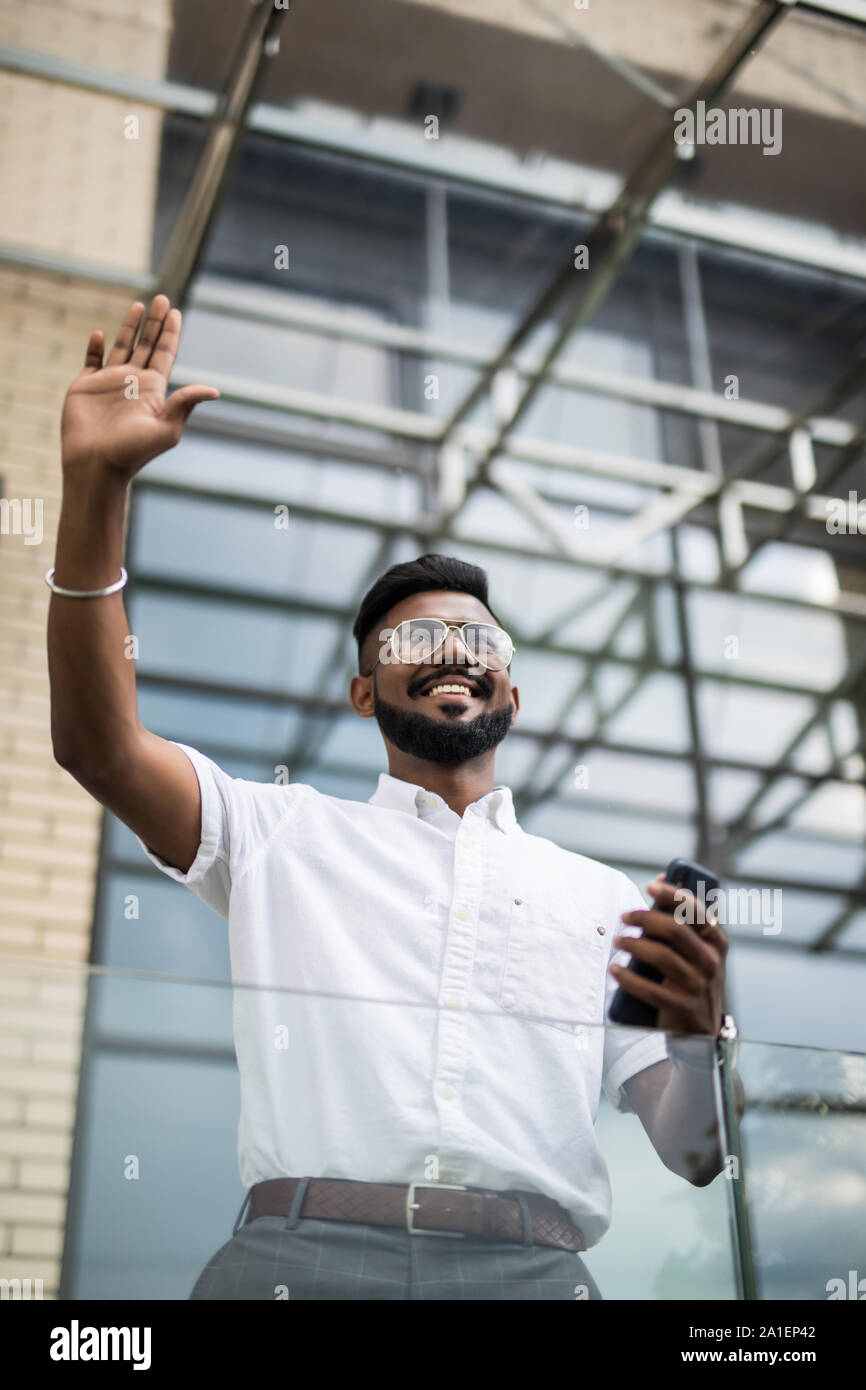 Serious indian businessman in eye glasses looking on copy space while ...