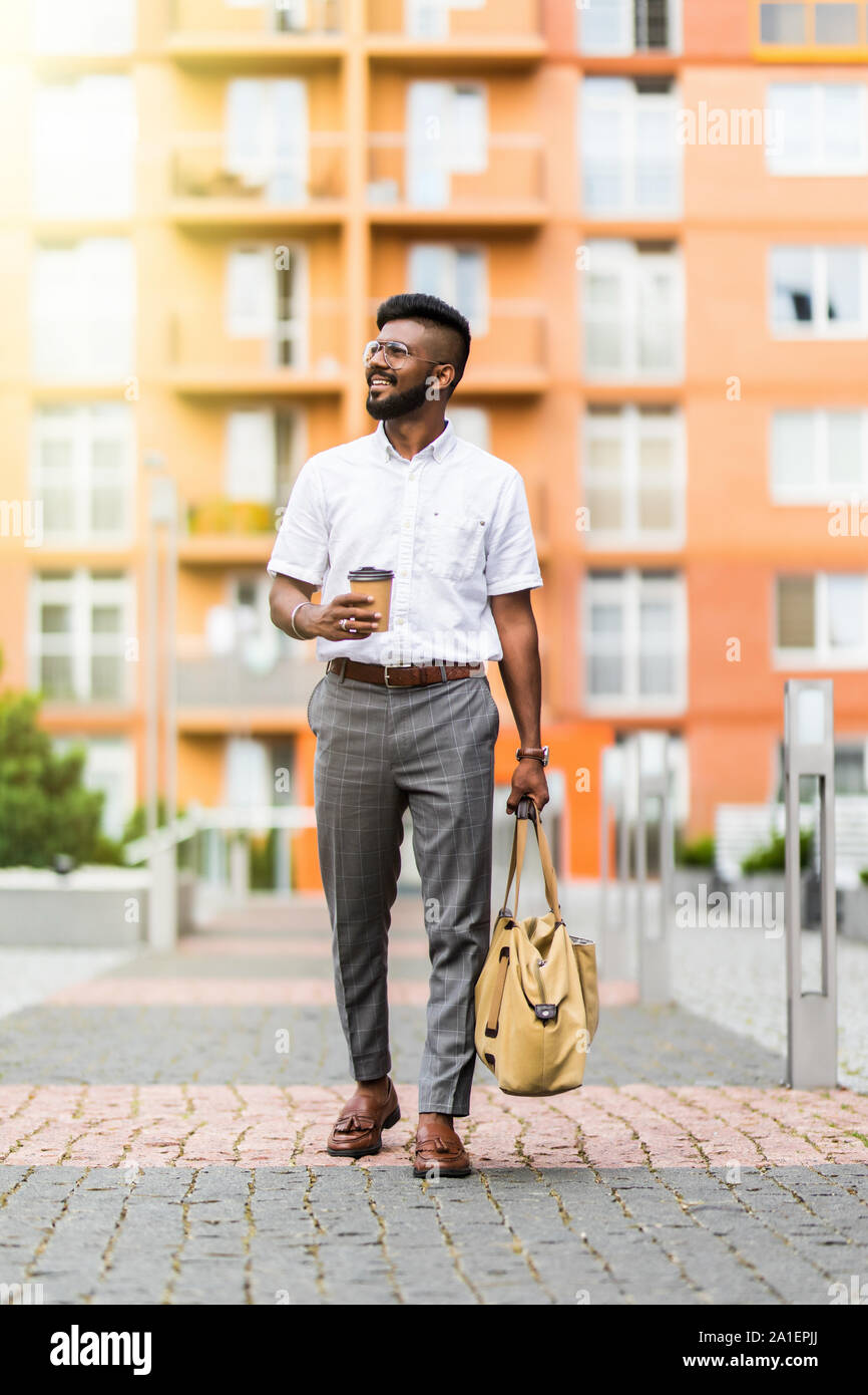travel, tourism and lifestyle concept - smiling indian man with ...