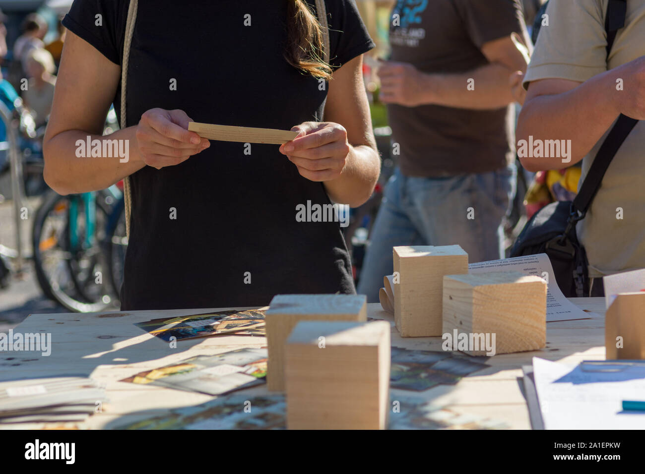 Female customer reading leaflet at outdoor market Stock Photo - Alamy