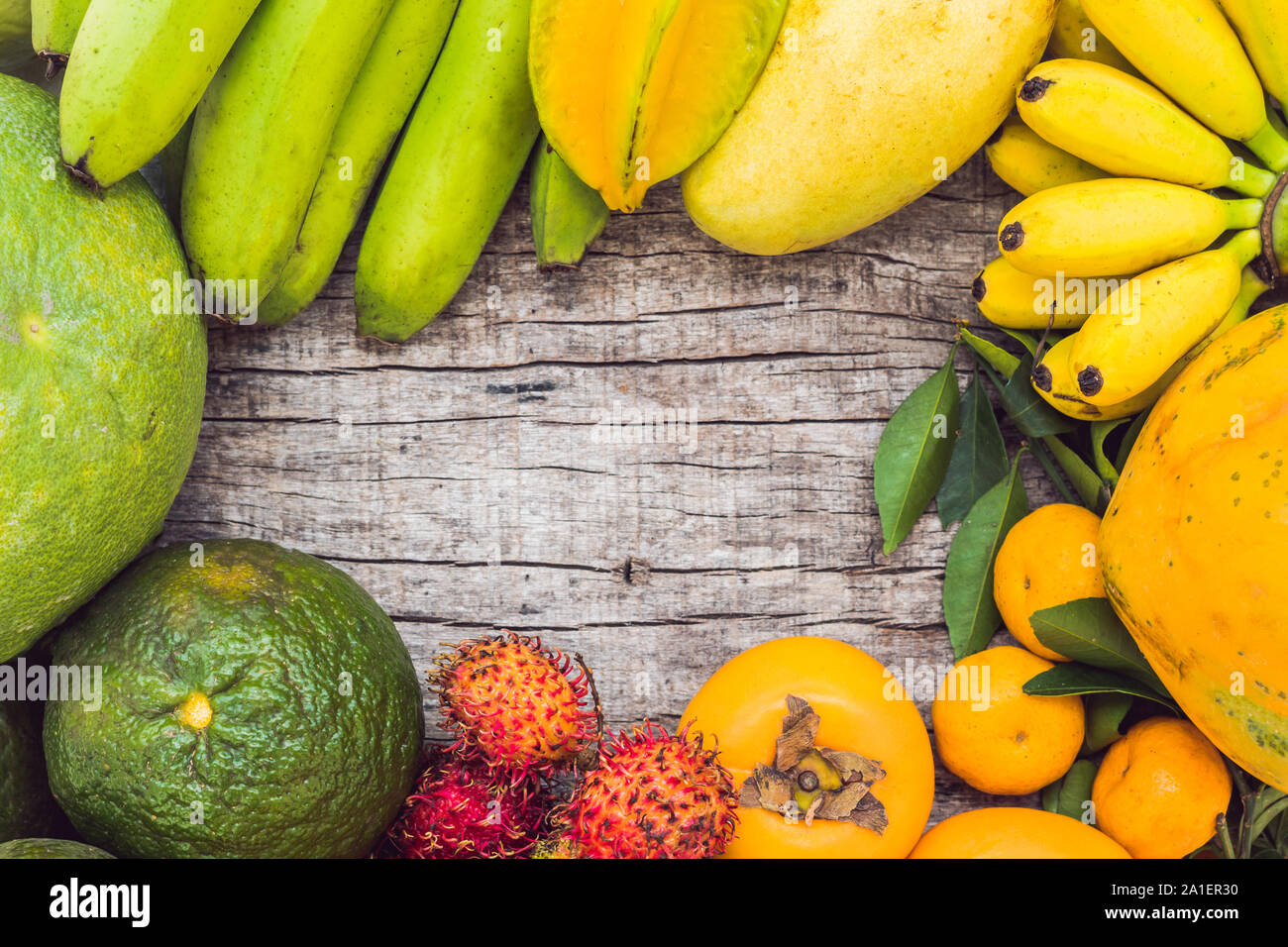 Colorful fruits on the white wooden table, Bananas, carambola, mango ...