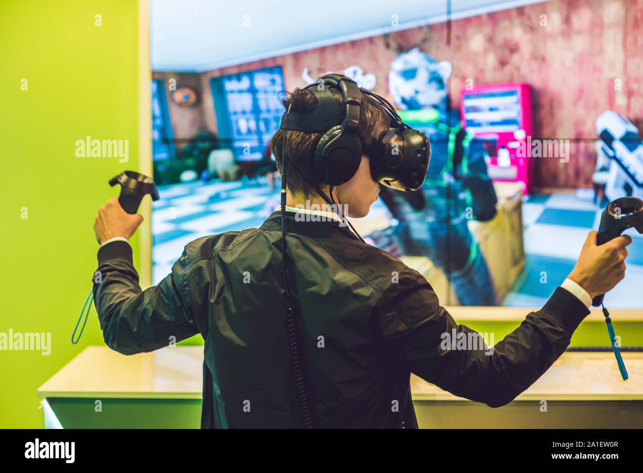 Young man playing video games virtual reality glasses. Cheerful man ...