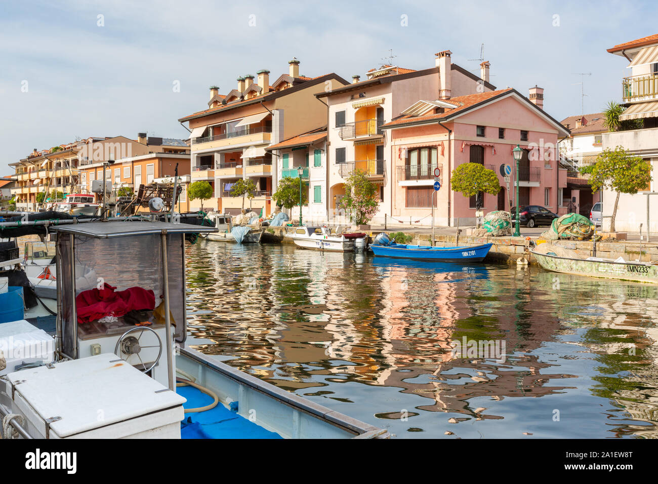 JULY 22, 2019 - GRADO, ITALY - Colored residential buildings and boats ...