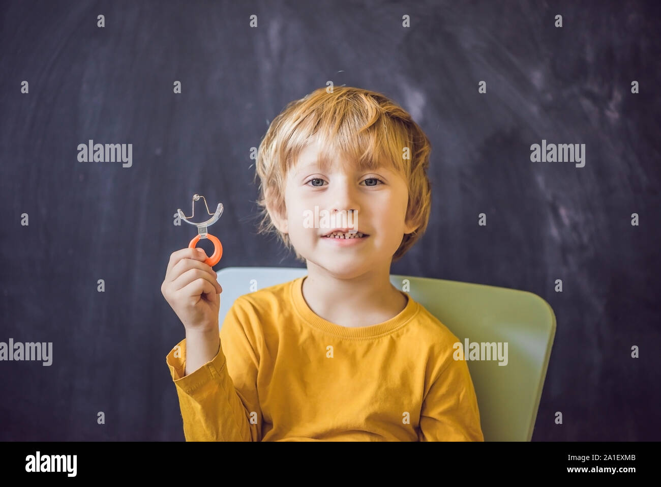 Three-year old boy shows vestibular plate. Plate with a bead to ...