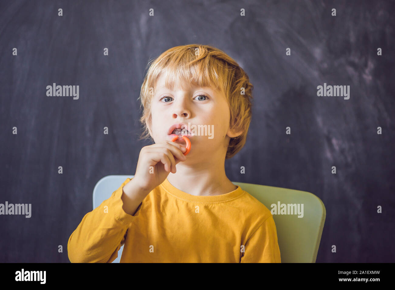 Three-year old boy shows vestibular plate. Plate with a bead to ...