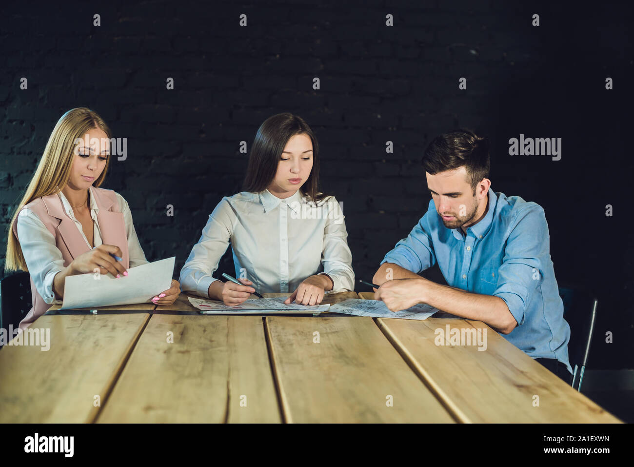 Young team of coworkers watching storyboard for shooting video in ...