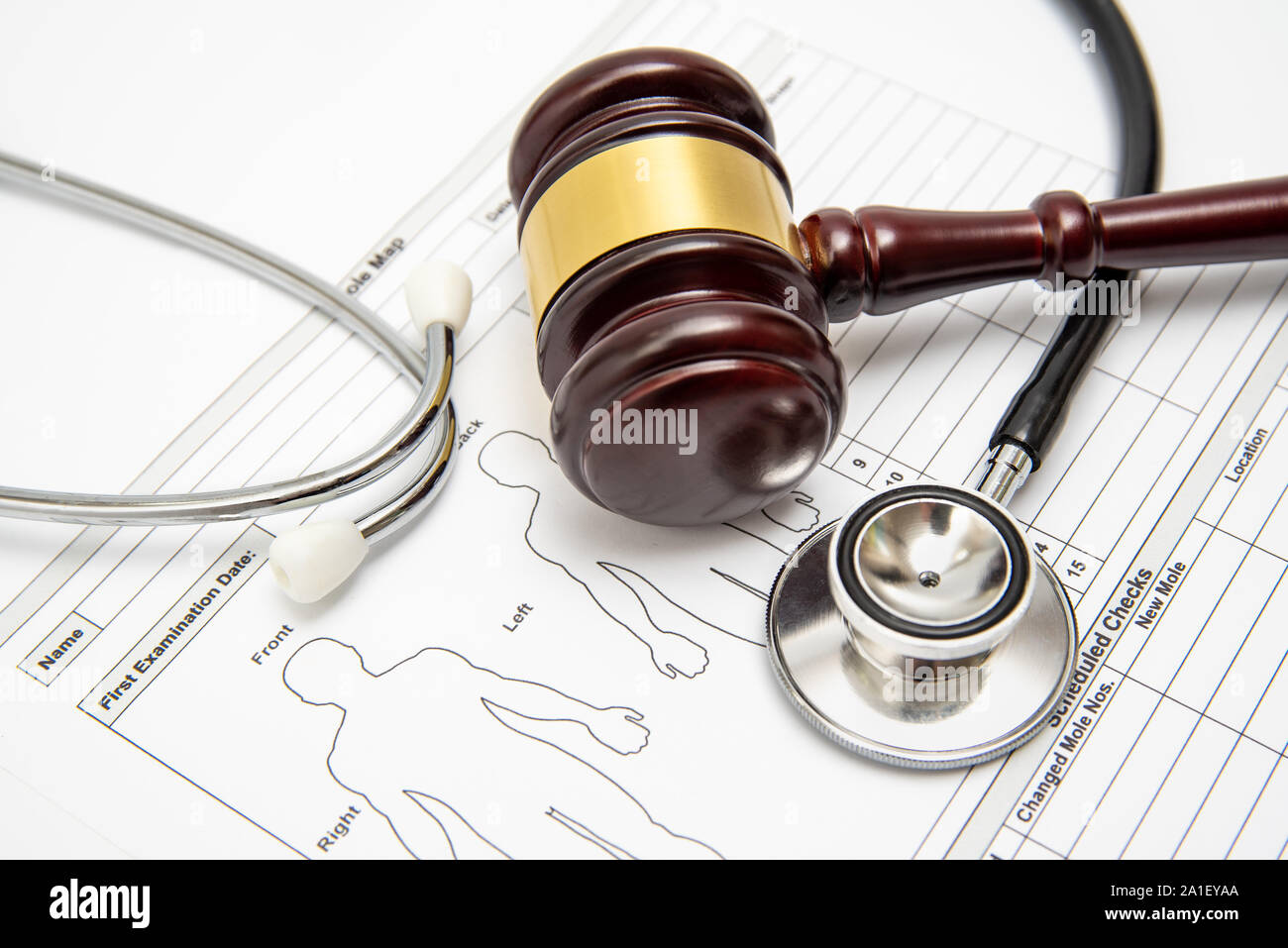 A wooden judge gavel and stethoscope on a medical chart. Medical ...