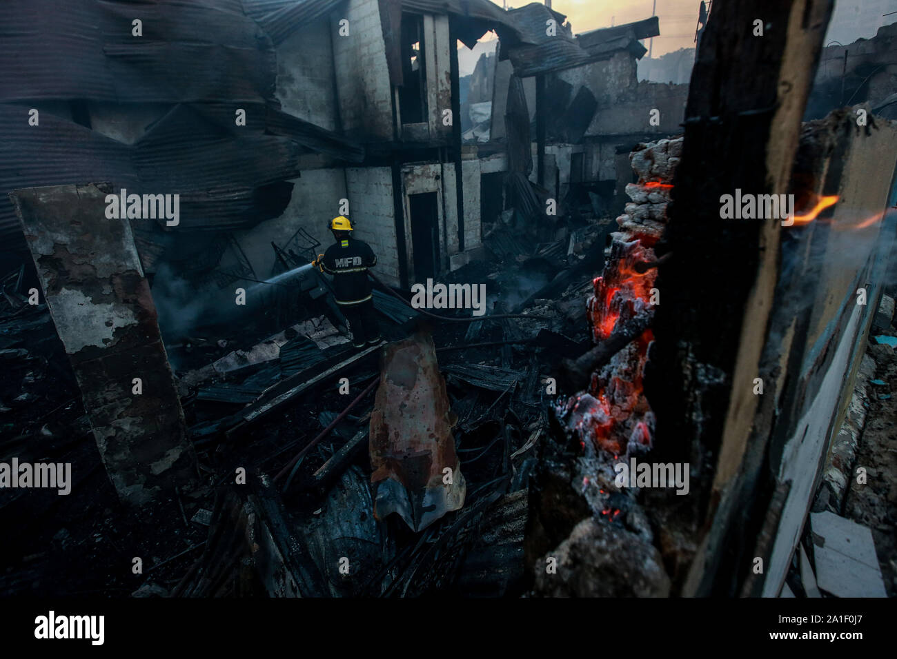 Manila, Philippines. 26th Sep, 2019. A firefighter tries to put out a ...