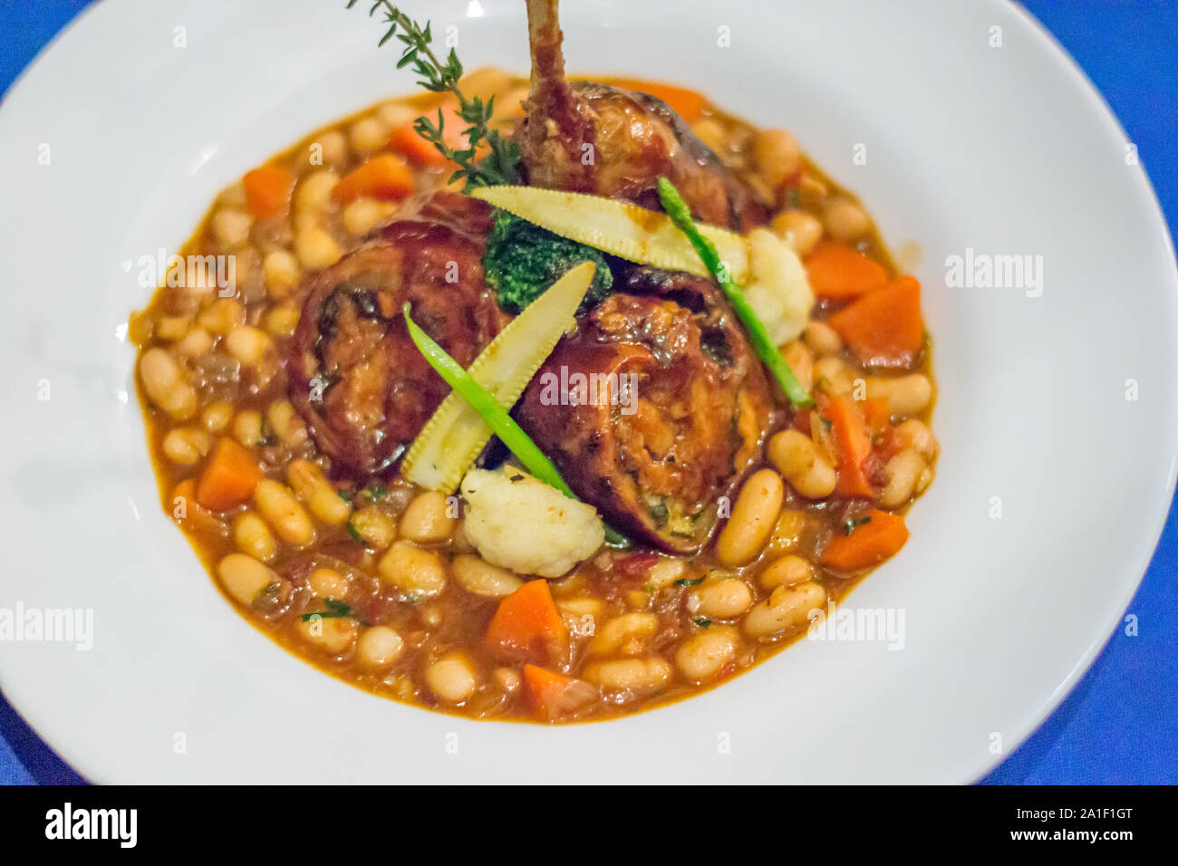 Portuguese Rabbit with White Bean and carrot Stew served in a white ...