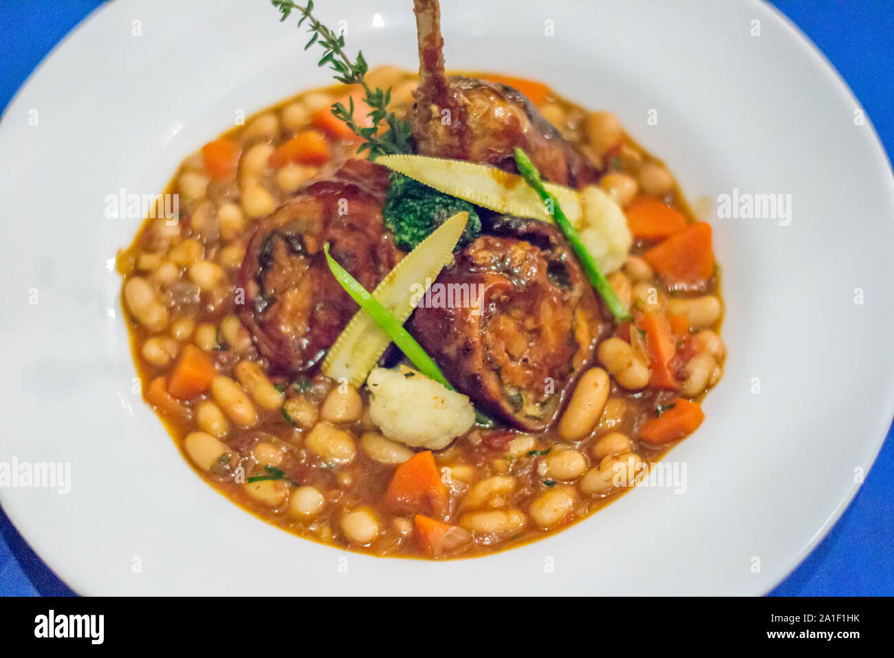 Portuguese Rabbit with White Bean and carrot Stew served in a white ...