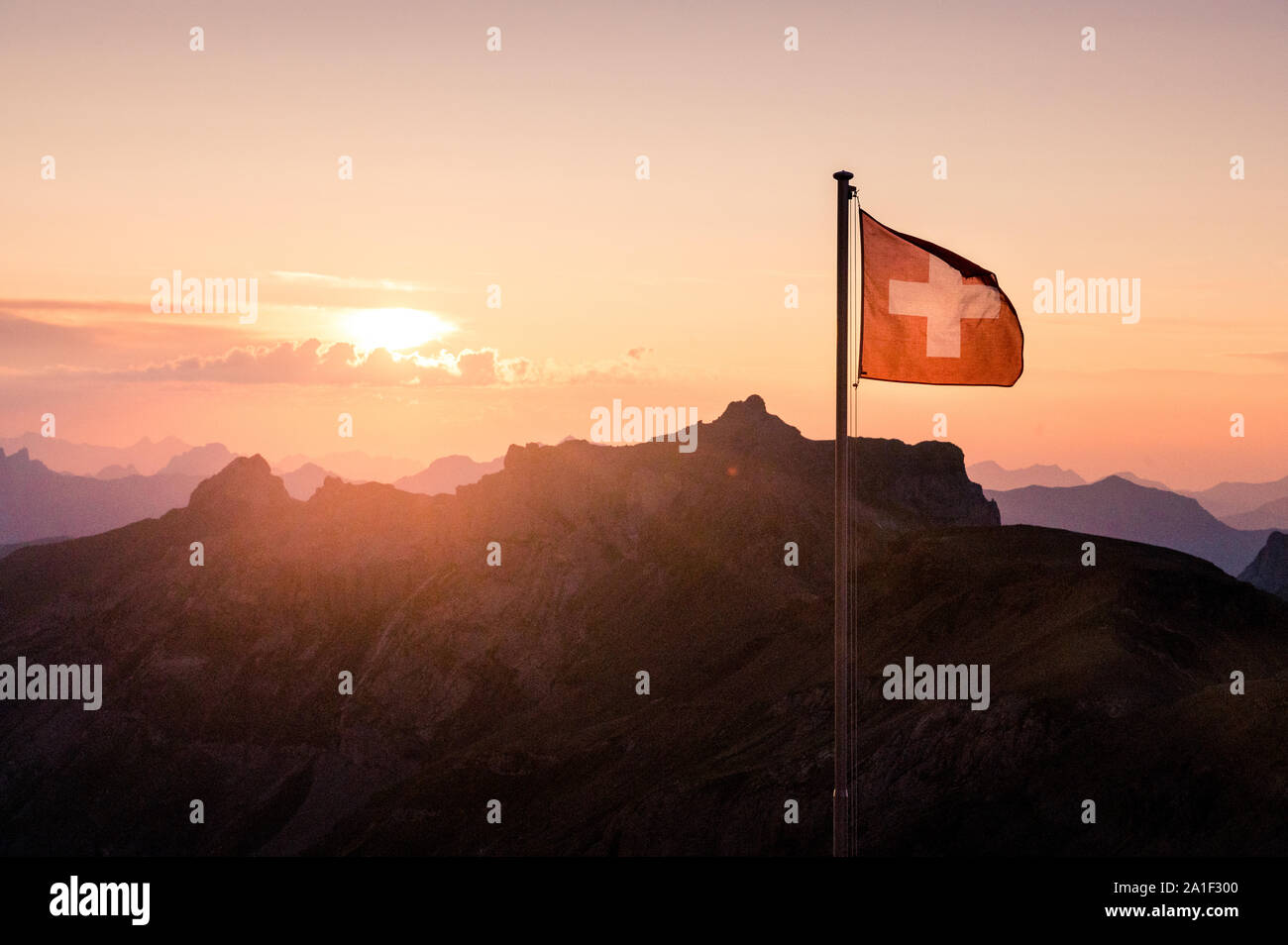 backlit swiss flag at sunset in the Swiss Alps Stock Photo - Alamy