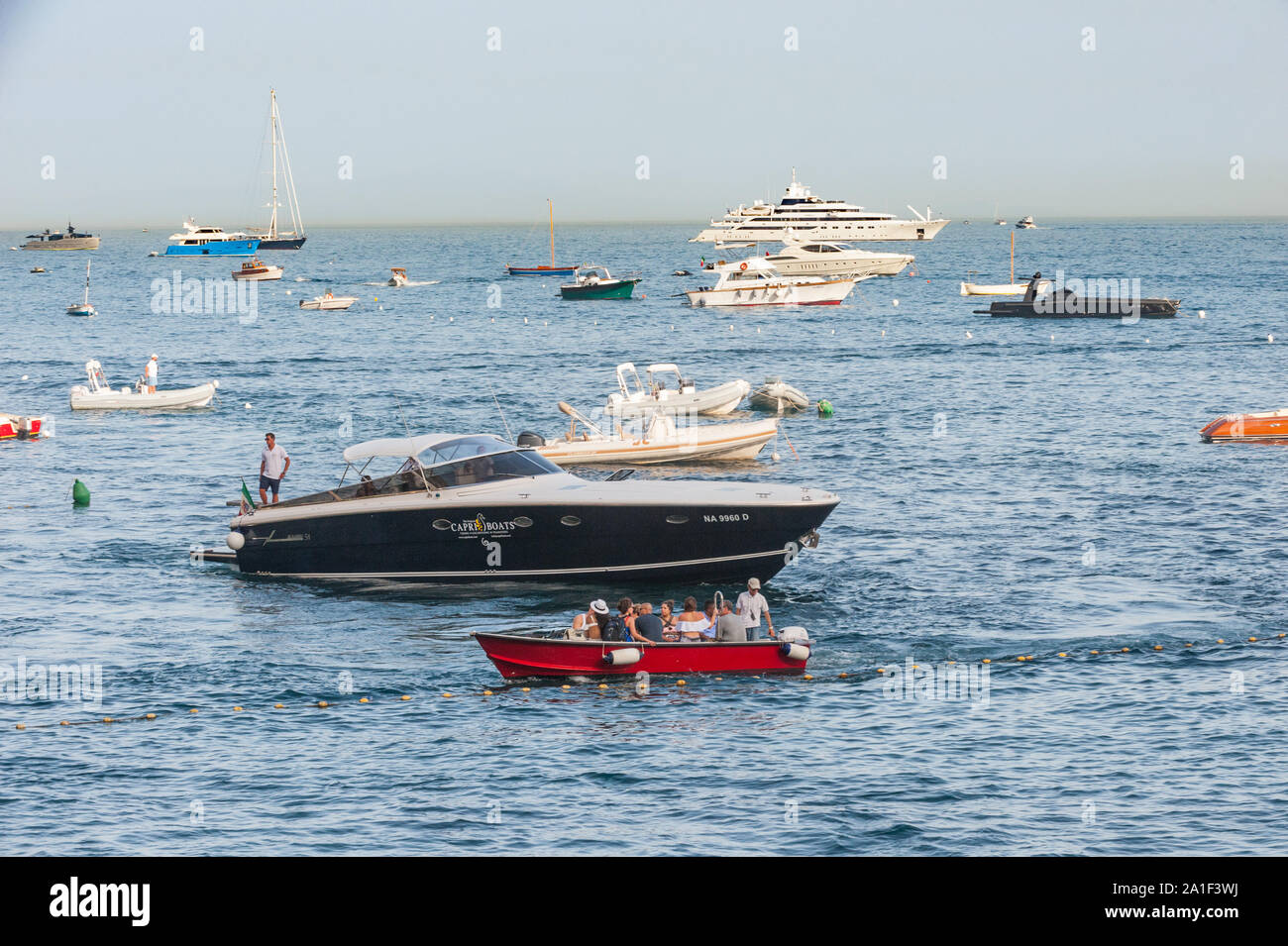Positano crowdy beach with lot of boats Stock Photo - Alamy