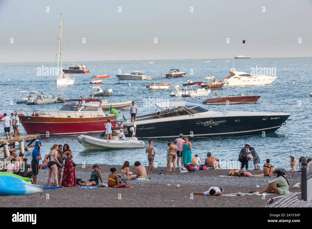 Positano crowdy beach with lot of boats Stock Photo - Alamy