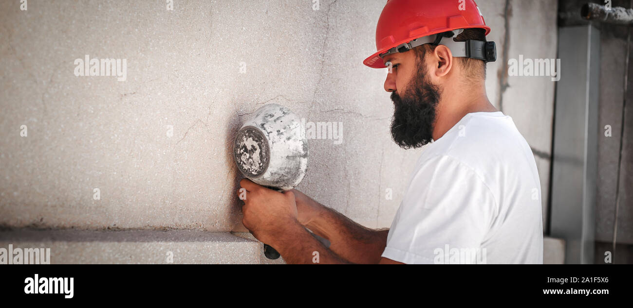 Construction mason worker plastering old building wall using cement ...
