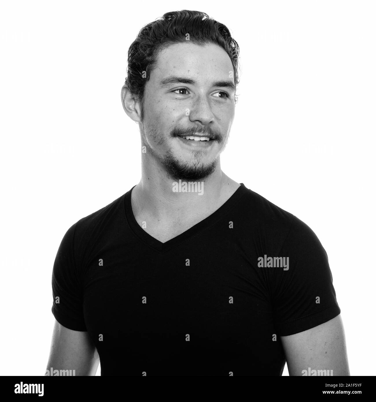 Close up of young happy man smiling and thinking isolated against white ...