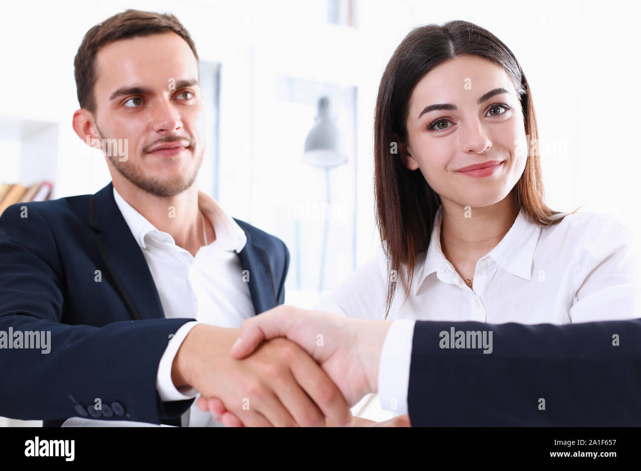 Smiling man in suit shake hands as hello Stock Photo - Alamy